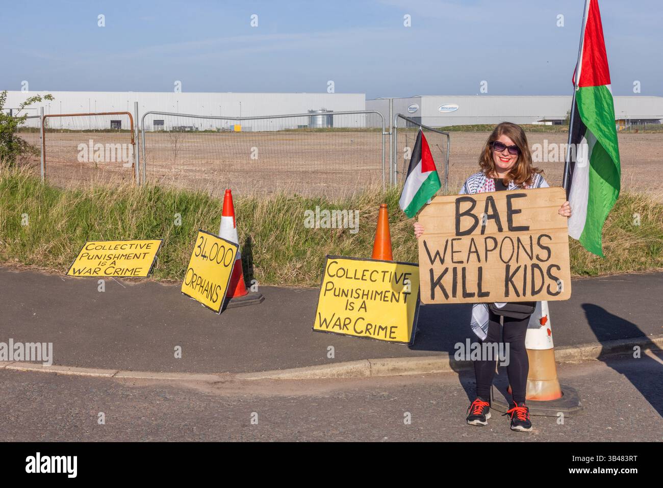 Samlesbury, UK. 30 APR, 2025. Activist holds "BAE weapons kill kids ...