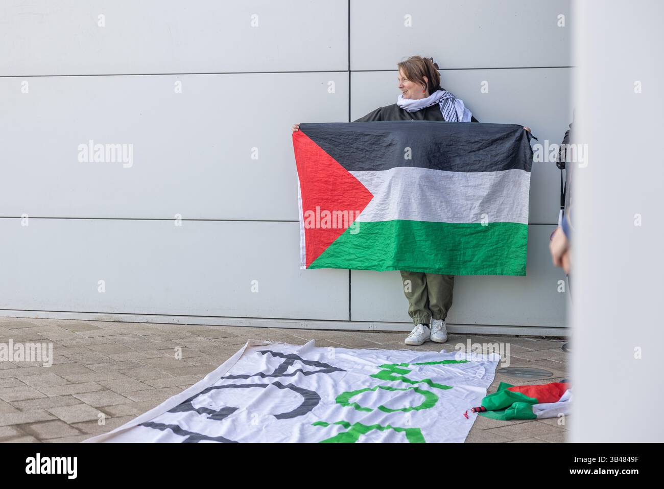 Samlesbury, UK. 30 APR, 2025. Person holds Palestine flag as activists ...