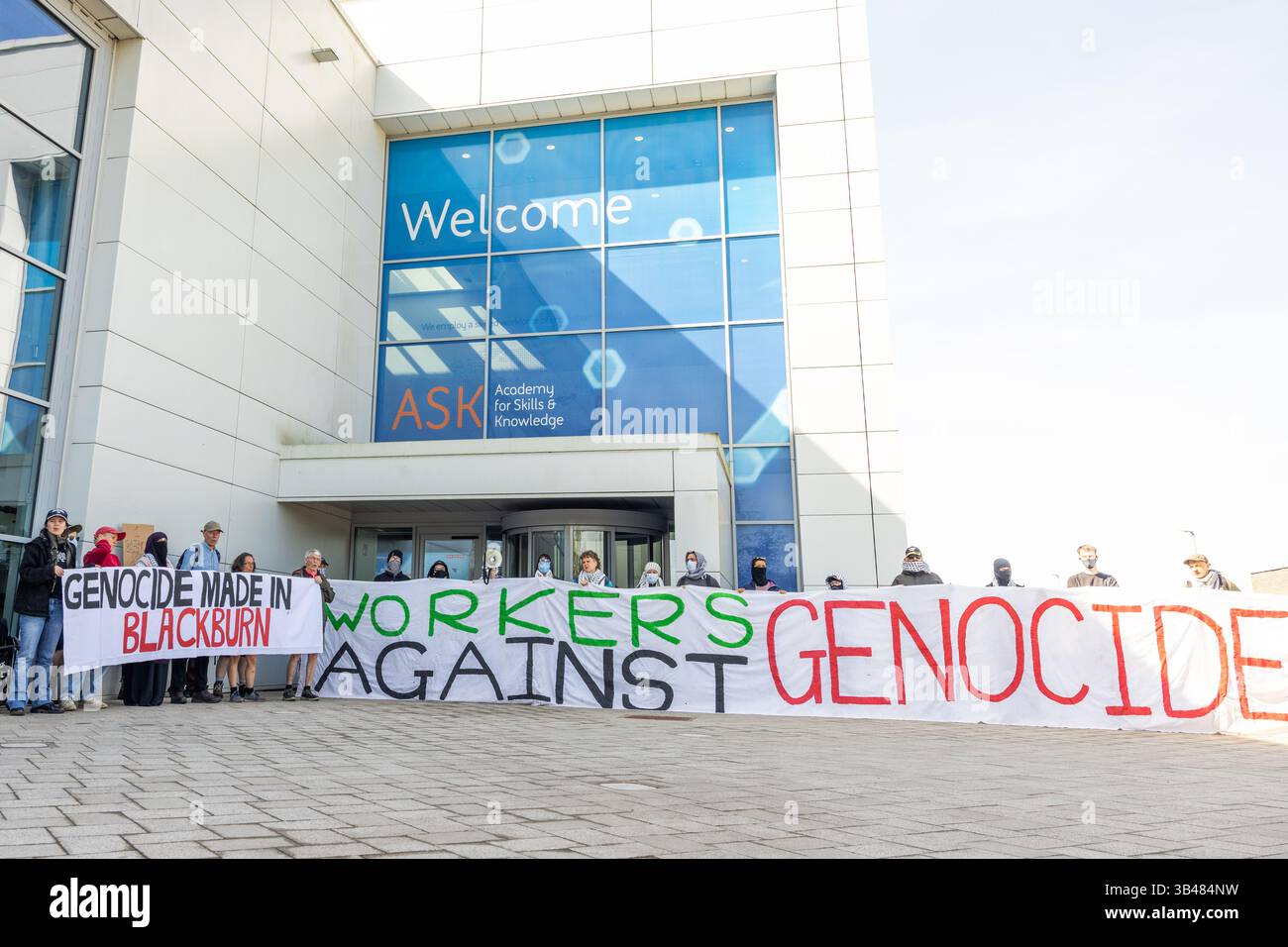 Samlesbury, UK. 30 APR, 2025. Activists hold banners outside the ...