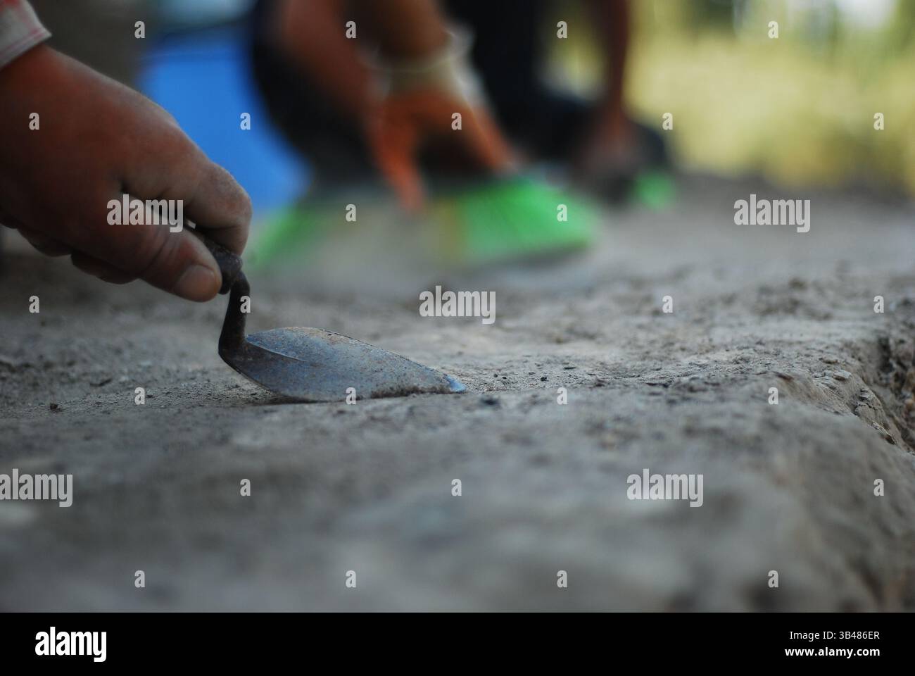 Archaeologist Carefully Excavating Charred Sediment Layers to Uncover ...