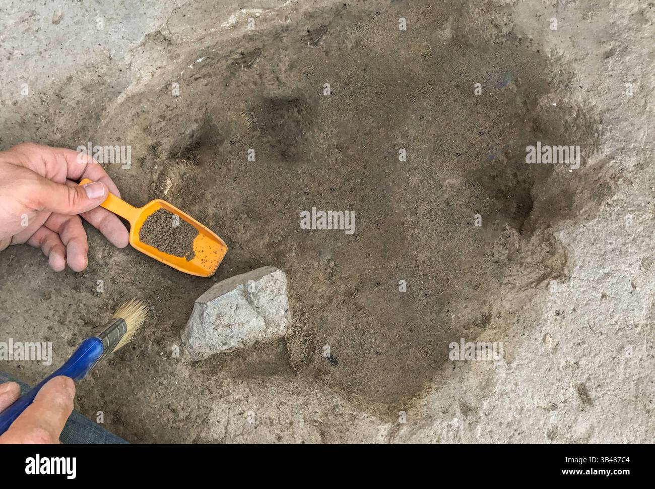 Archaeologist Carefully Excavating Charred Sediment Layers to Uncover ...