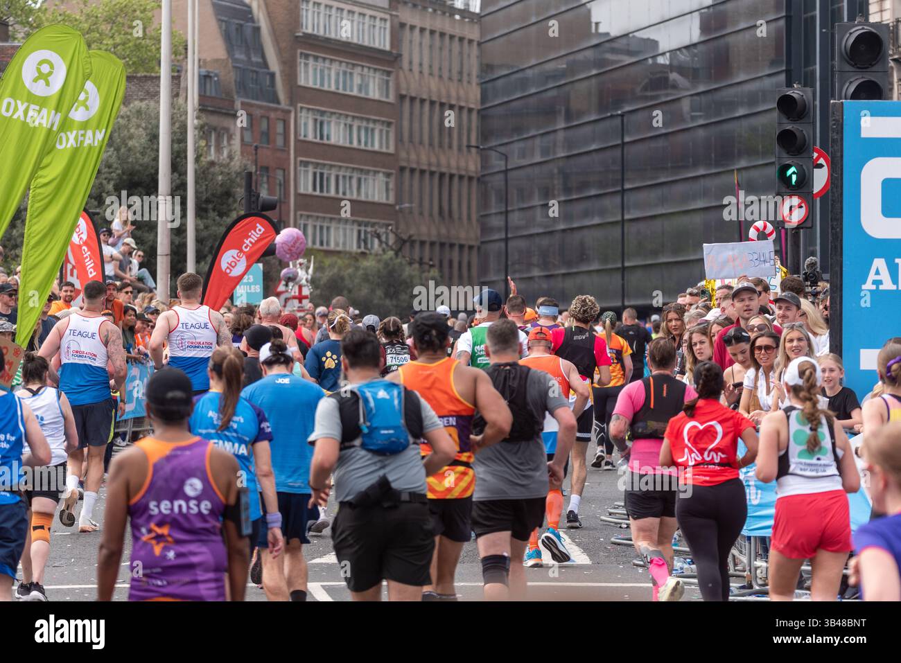 Rear of fun runners competing in the 2025 TCS London Marathon, passing ...