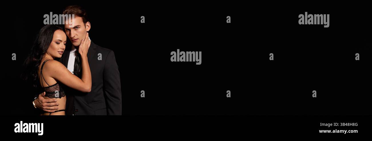 A couple stands together, expressing deep love and passion as they gaze ...