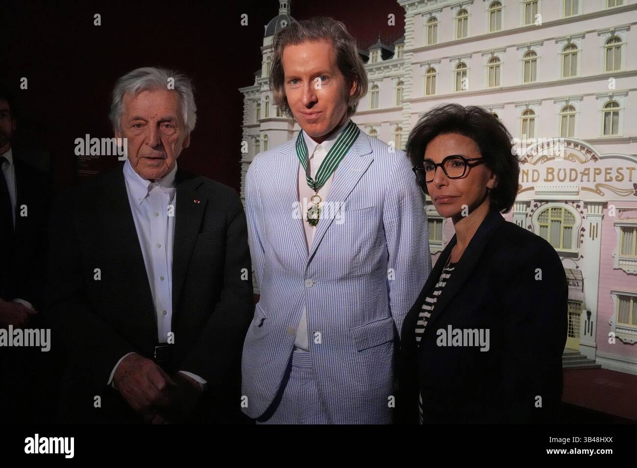 Director Wes Anderson, center, poses after being awarded Knight of Arts ...