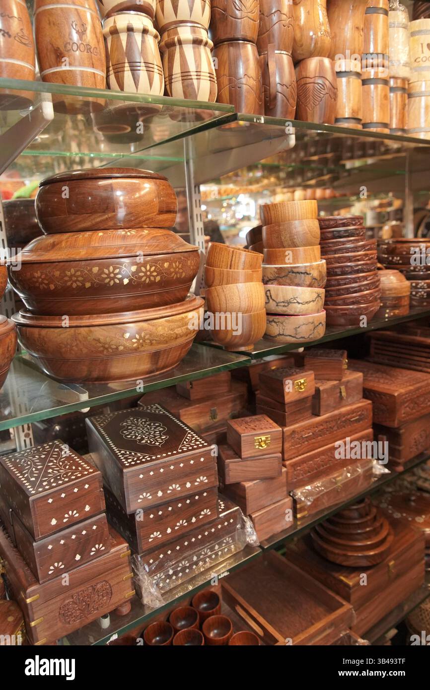 A set of intricately inlaid wooden handcrafts with lids, displayed in a ...