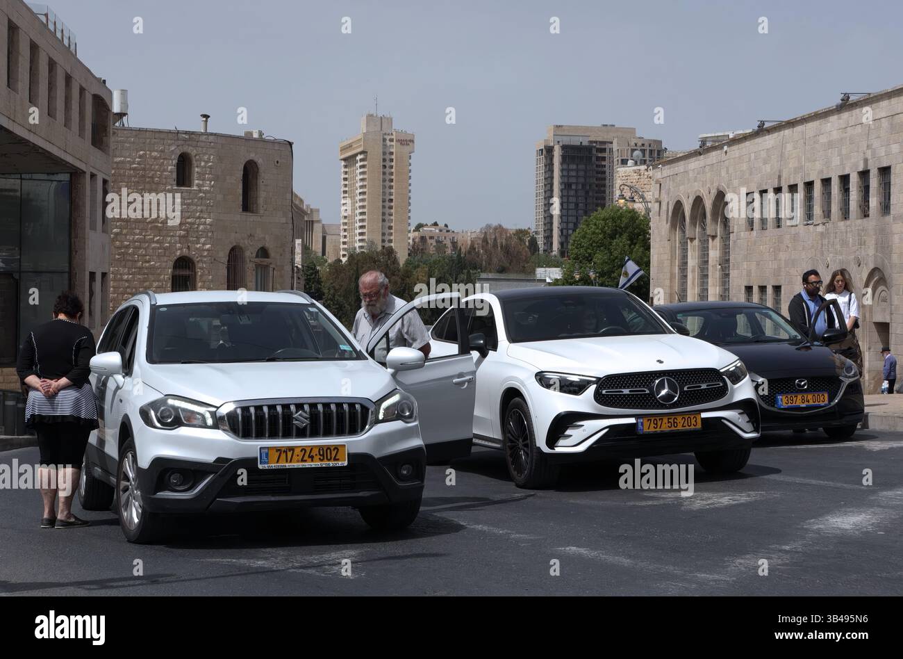 Israelis stand still outside their cars as a two-minute siren sounds ...