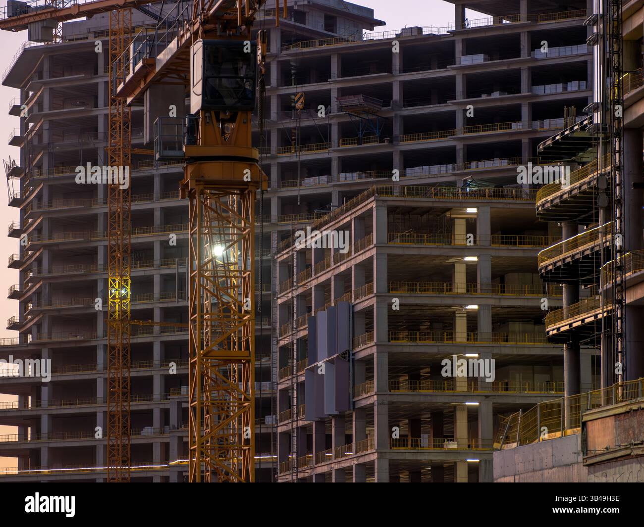 Modern skyscrapers under construction with cranes, symbolizing urban ...