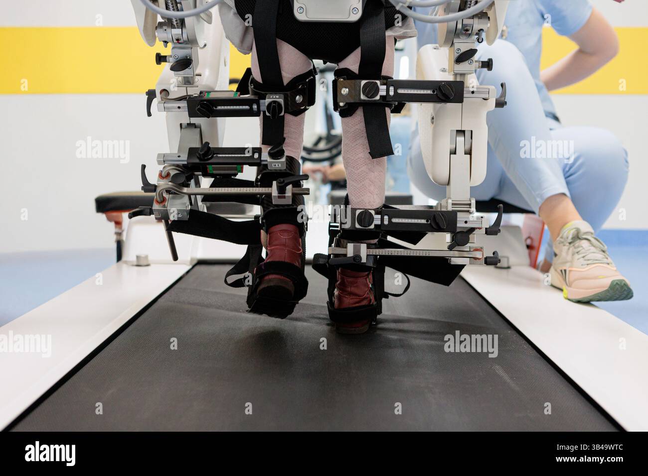 Child on robotic gait trainer during walking therapy session at ...