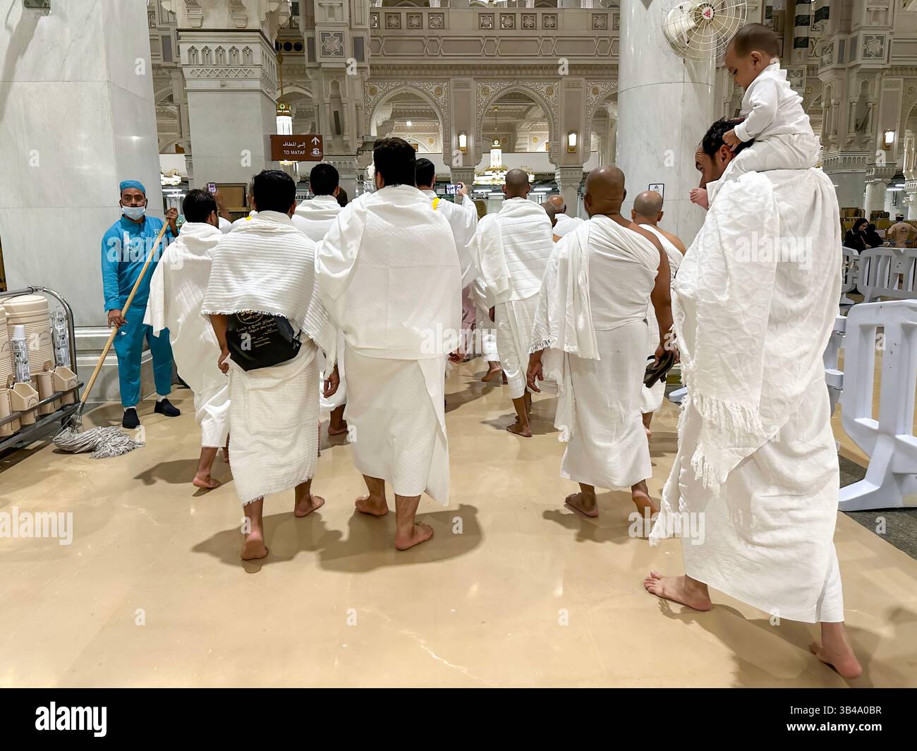 Male pilgrims in ihram go to pray in Al Haram Mosque. Saudi Arabia ...