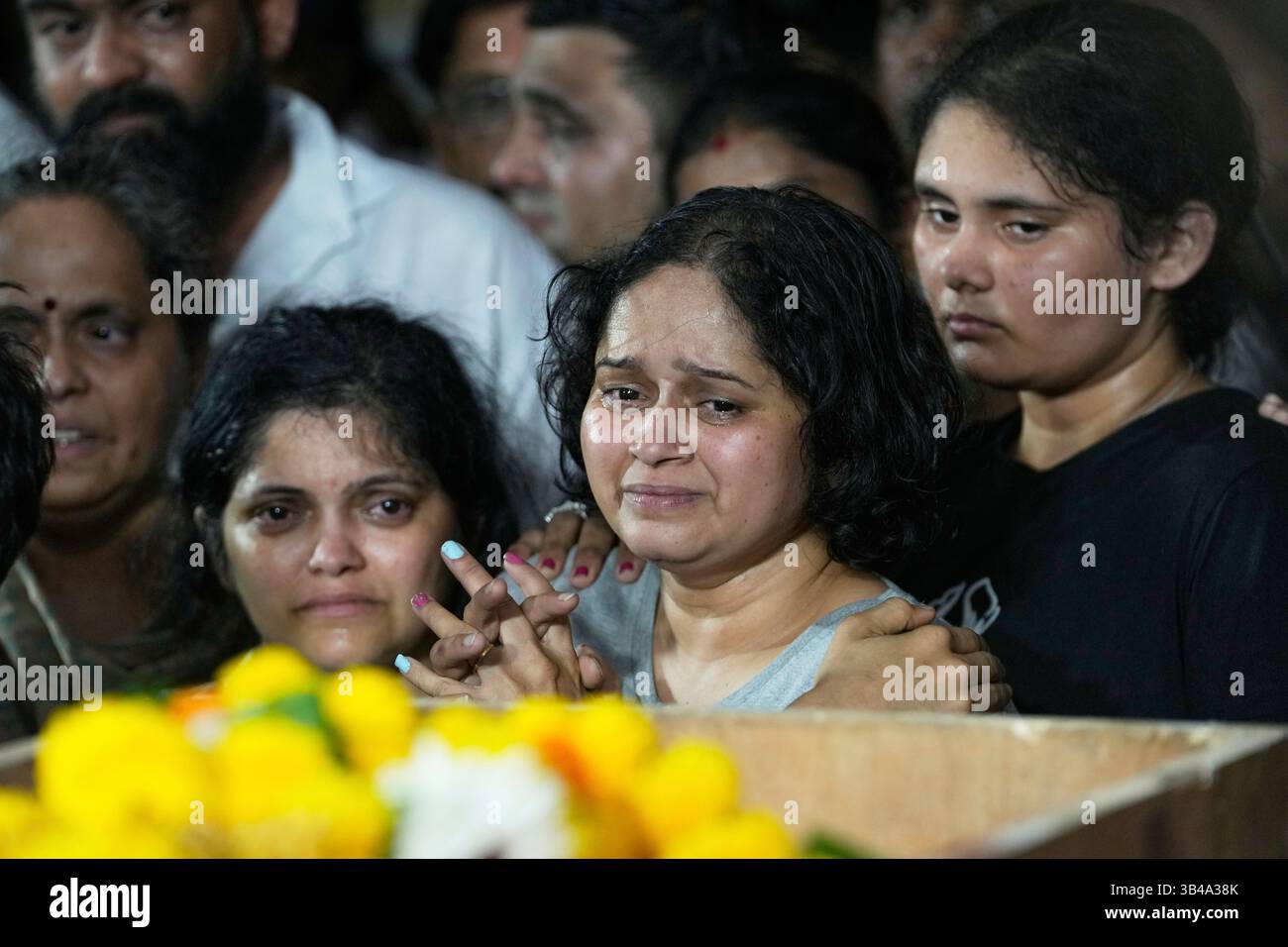 Anushka Mone, second right, wails next to the body of her husband Atul ...