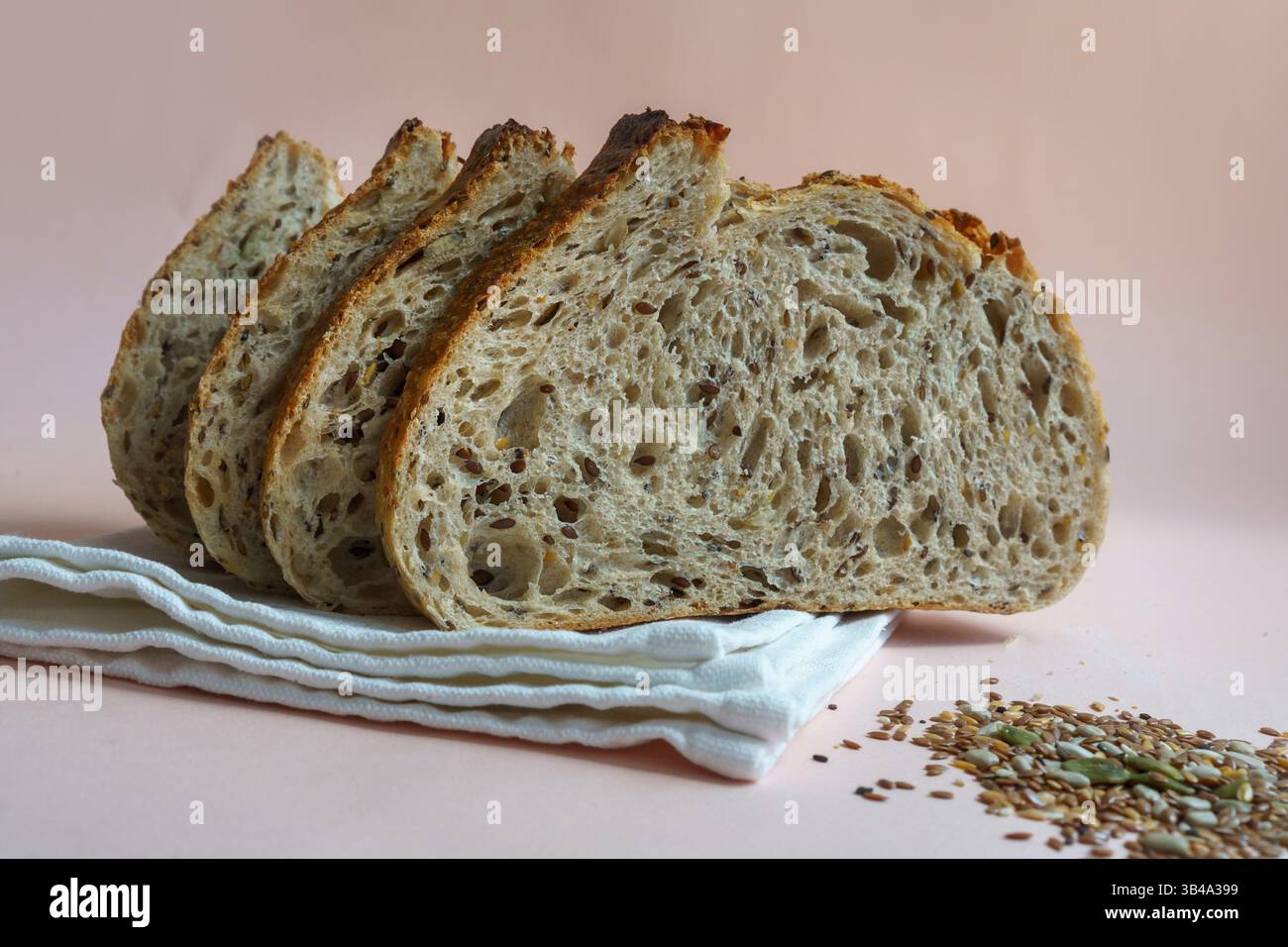 classic artisan healthy tartine bread with sesame, sunflower, flax seeds in cross section ...