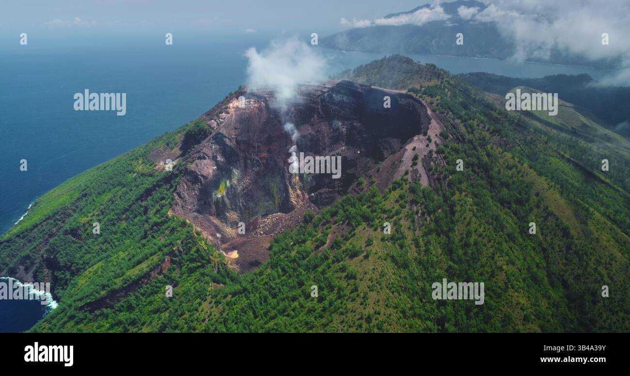 Aerial drone view of Mount Iya volcano smoking crater partially covered ...