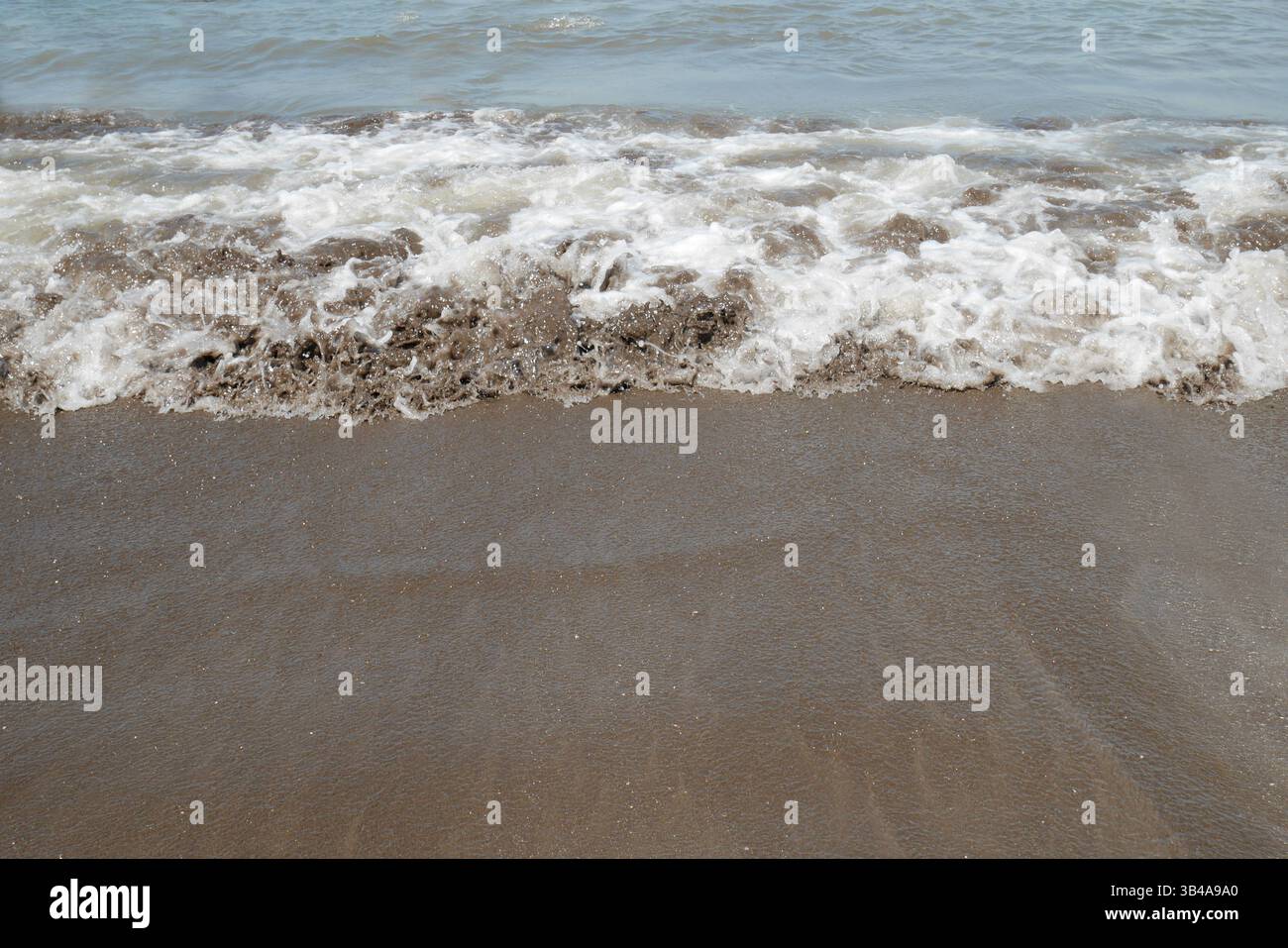 The coastline, boundary between sand and wave foam Stock Photo - Alamy