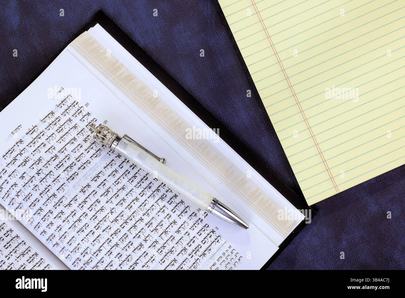 24 April 2025 Jerusalem Israel Notepad, silver pen sit beside an open ...