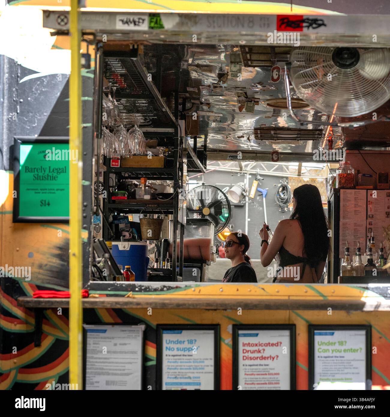 People at a street side beverage dispenser kiosk booth in the City of ...