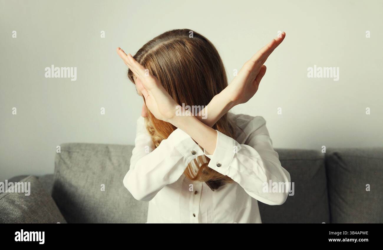 Close-up upset young woman shows stop, no or enough sign with palm of ...