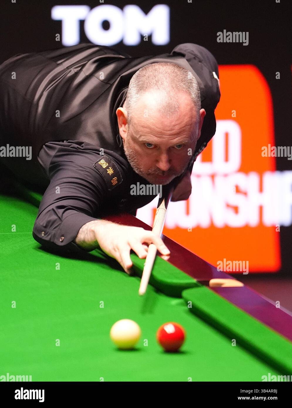 Mark Williams plays a shot during his game against John Higgins, on day ...