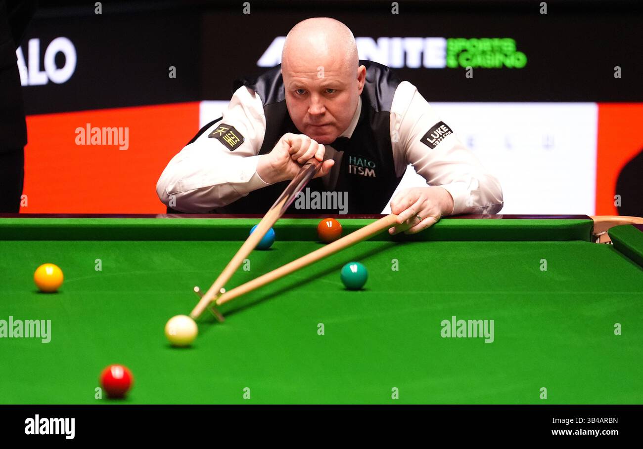 John Higgins plays a shot during his game against Mark Williams , on ...