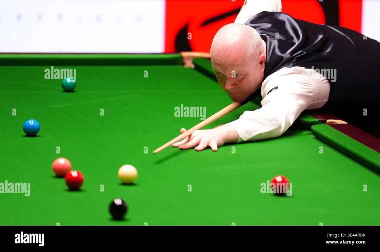 John Higgins plays a shot during his game against Mark Williams , on ...
