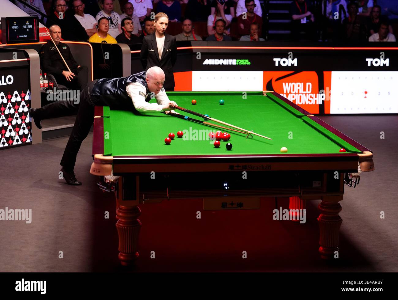 John Higgins plays a shot during his game against Mark Williams , on ...