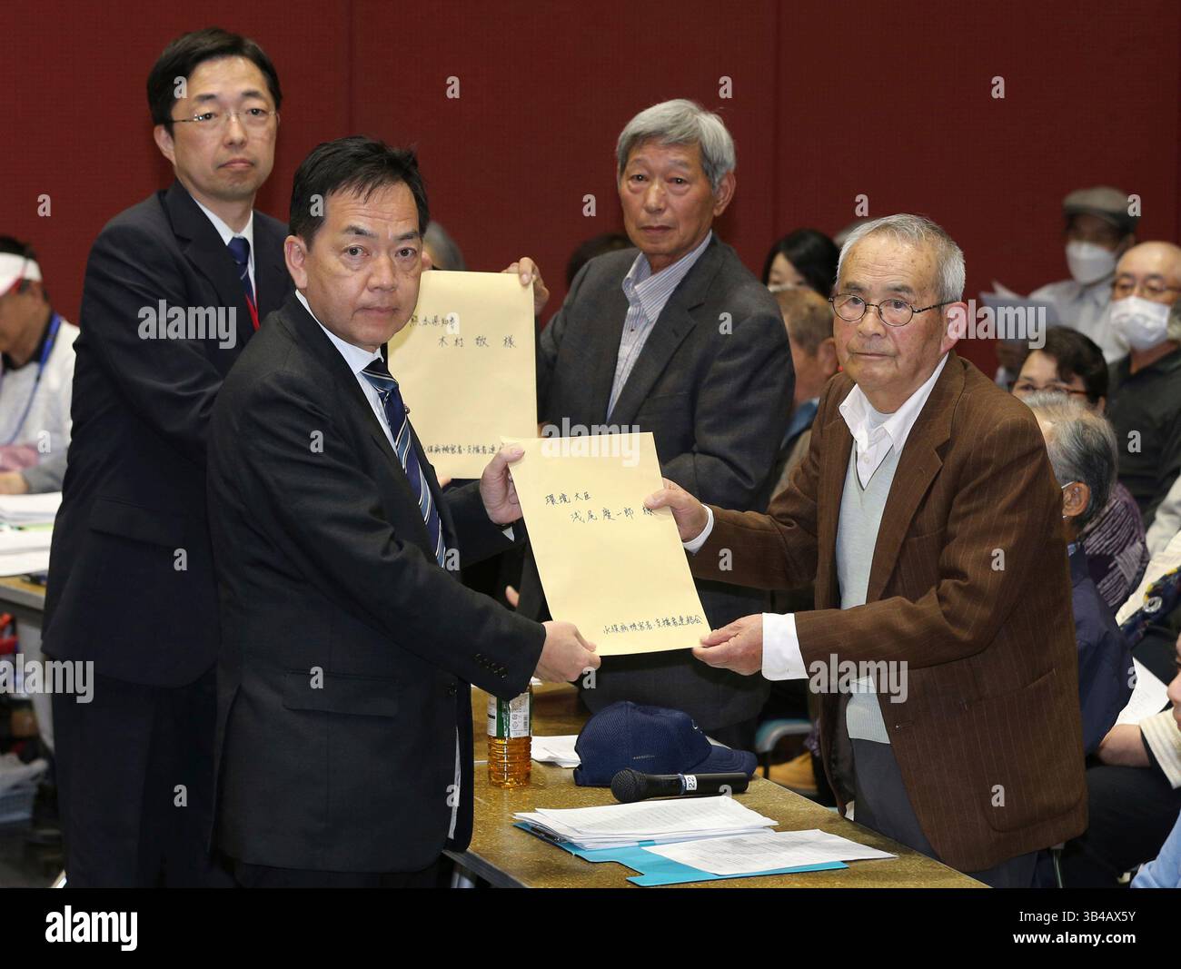 Japan's Environment Minister Keichiro ASAO (second from left) receives ...
