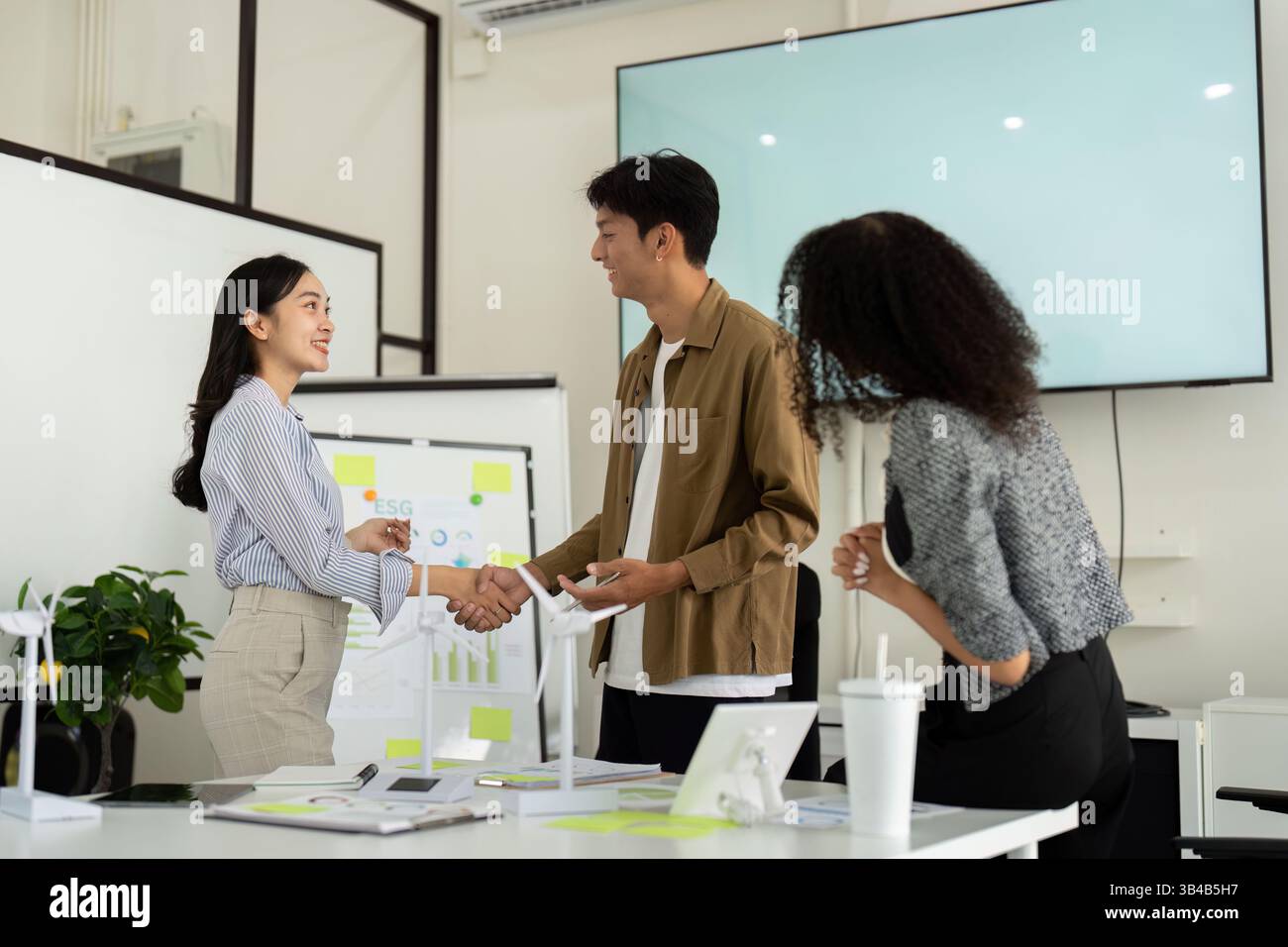 Sustainability celebration with young professionals exchanging success ...