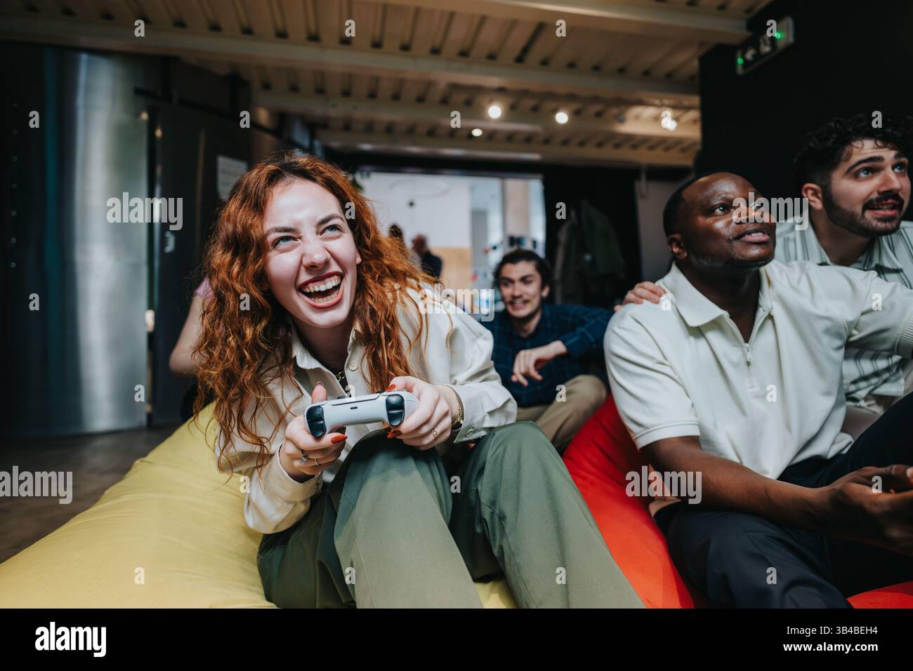 Diverse group of colleagues enjoying an engaging video game session ...
