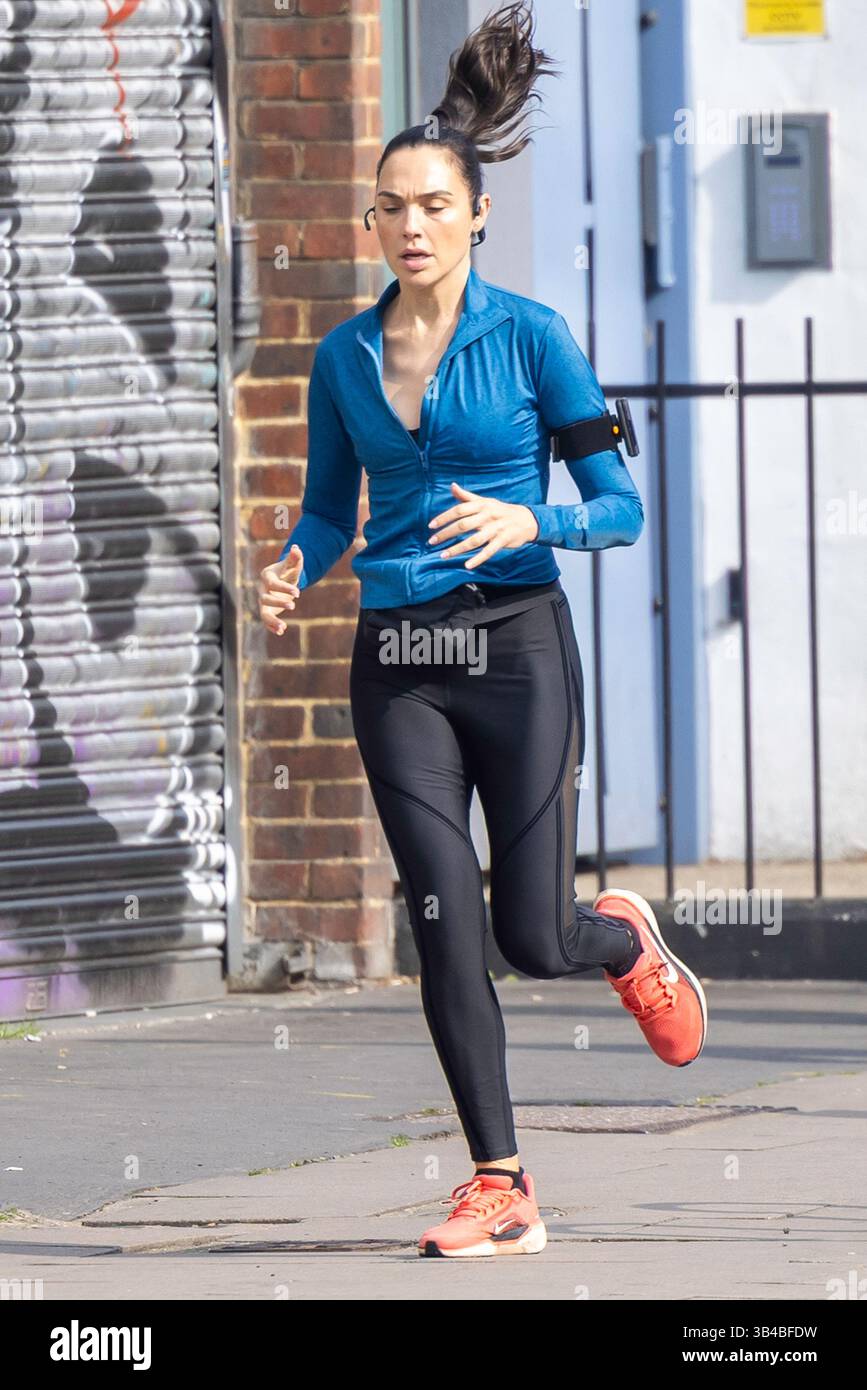 Gal Gadot filming a scene for 'The Runner' in Camden, London, wearing a blue running top and ...