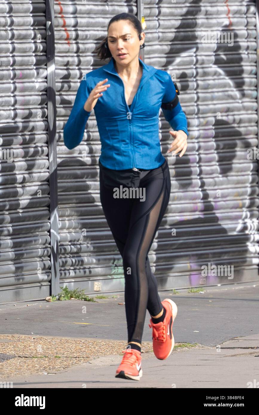 Gal Gadot filming a scene for 'The Runner' in Camden, London, wearing a blue running top and ...