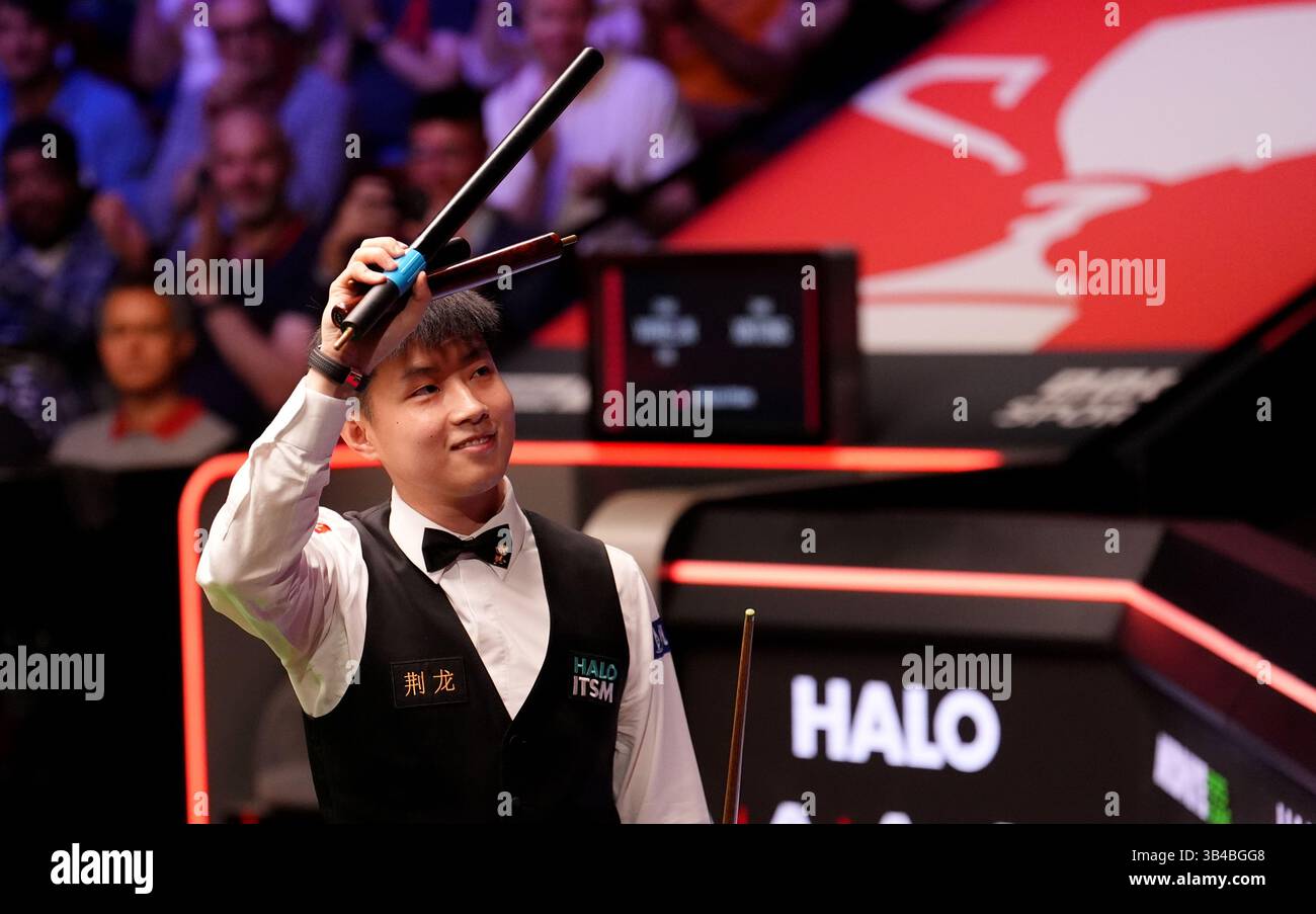 Zhao Xintong celebrates winning his match against Chris Wakelin, on day ...