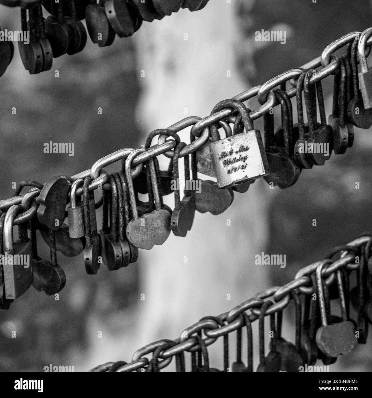 Locks on a chain Black and White Stock Photos & Images - Alamy