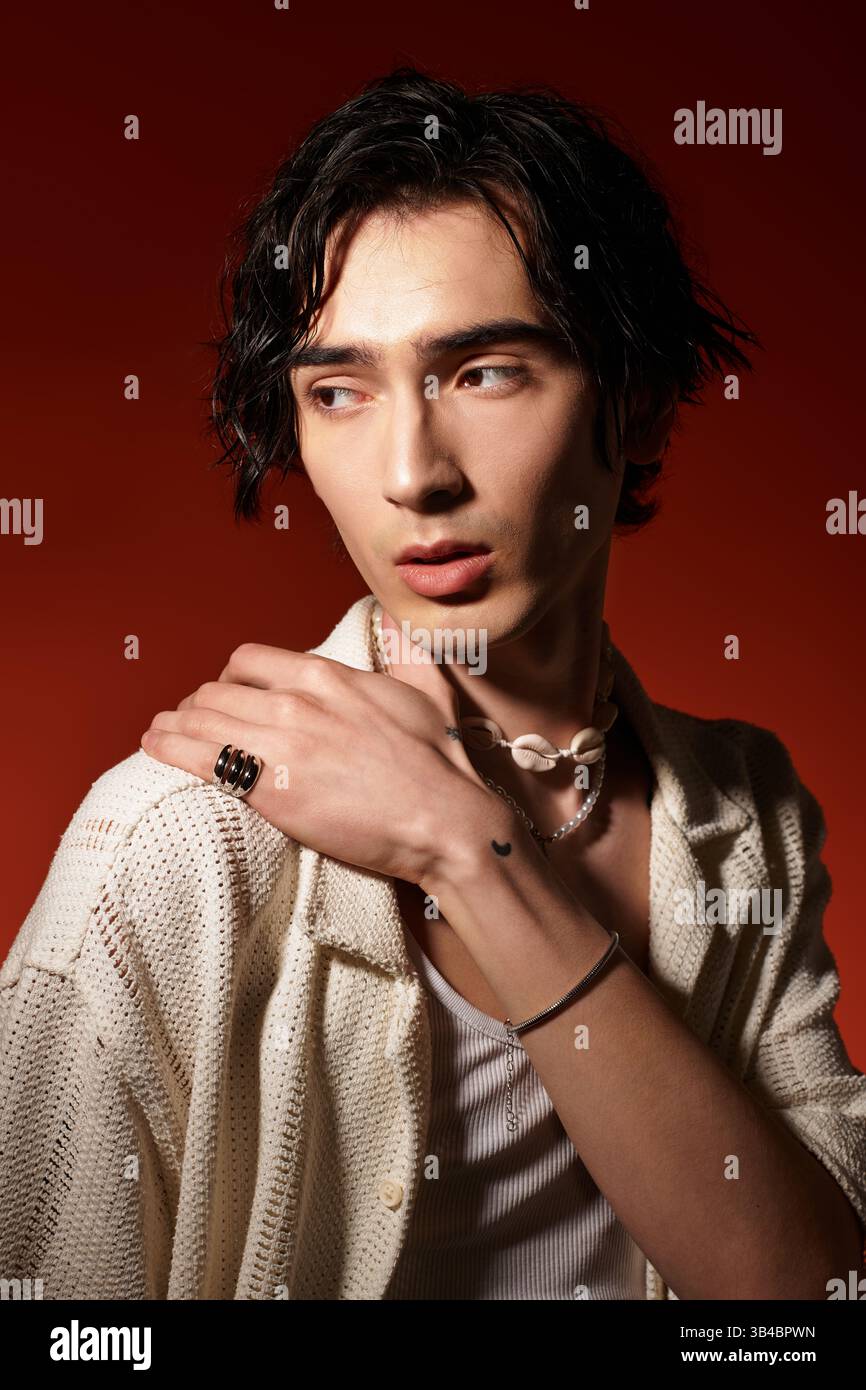 A slim young man poses confidently in a trendy summer outfit with ...