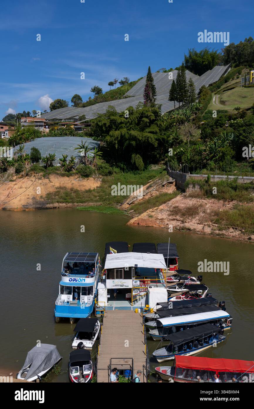 Tour boats at a dock on the Embalse Del Peñol or Guatape-Penol Reservoir in Colombia Stock Photo ...