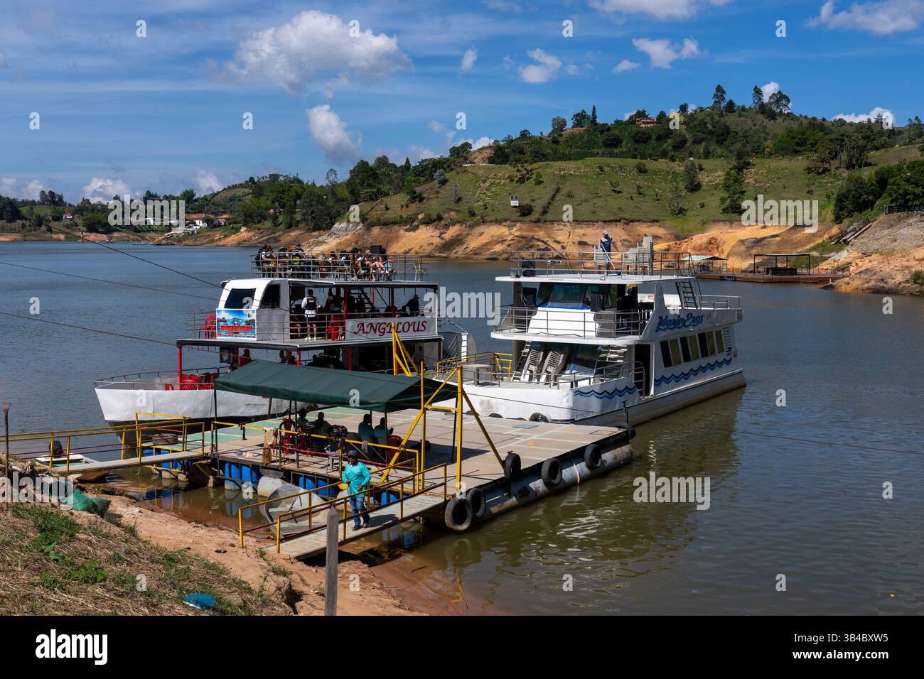 Tour boats at a dock on the Embalse Del Peñol or Guatape-Penol Reservoir in Colombia Stock Photo ...