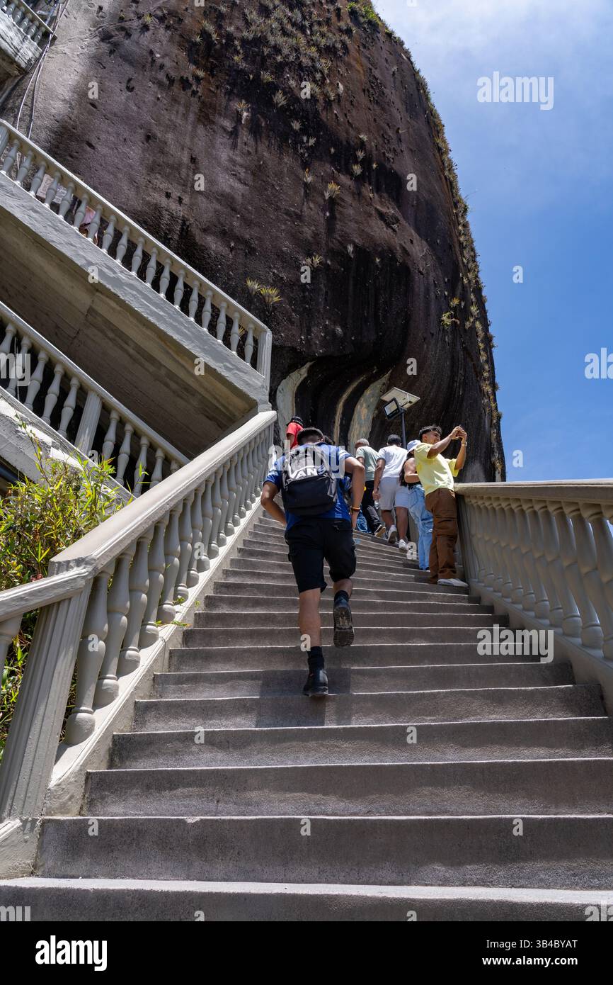 Tourists climb the 740 stairs to the top of the Piedra del Penon or Penon de Guatape, near ...
