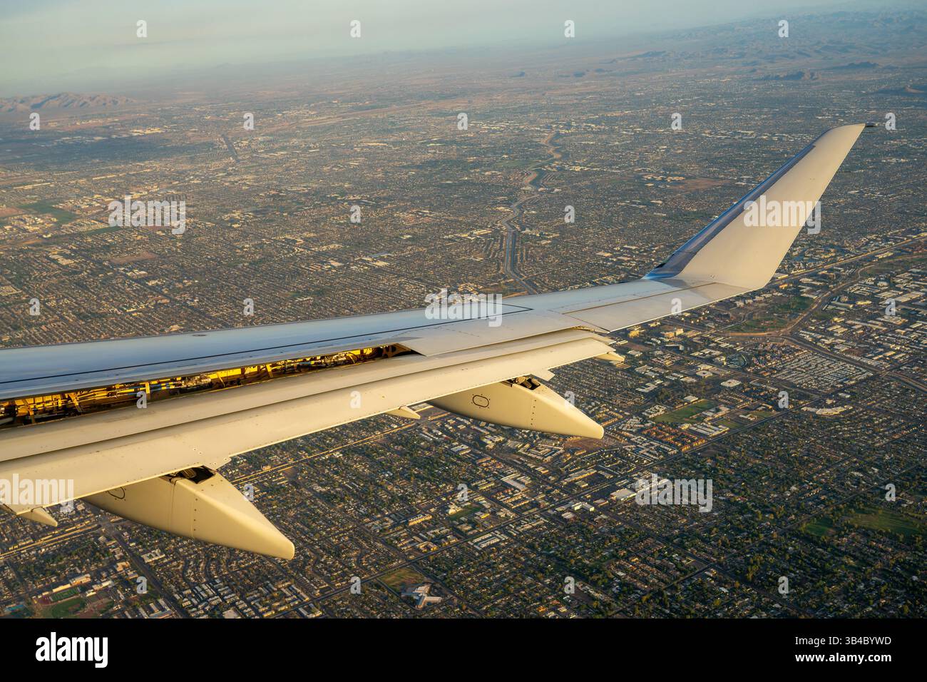 Aerial view of the city of Phoenix, Arizona beneath the wing of a ...