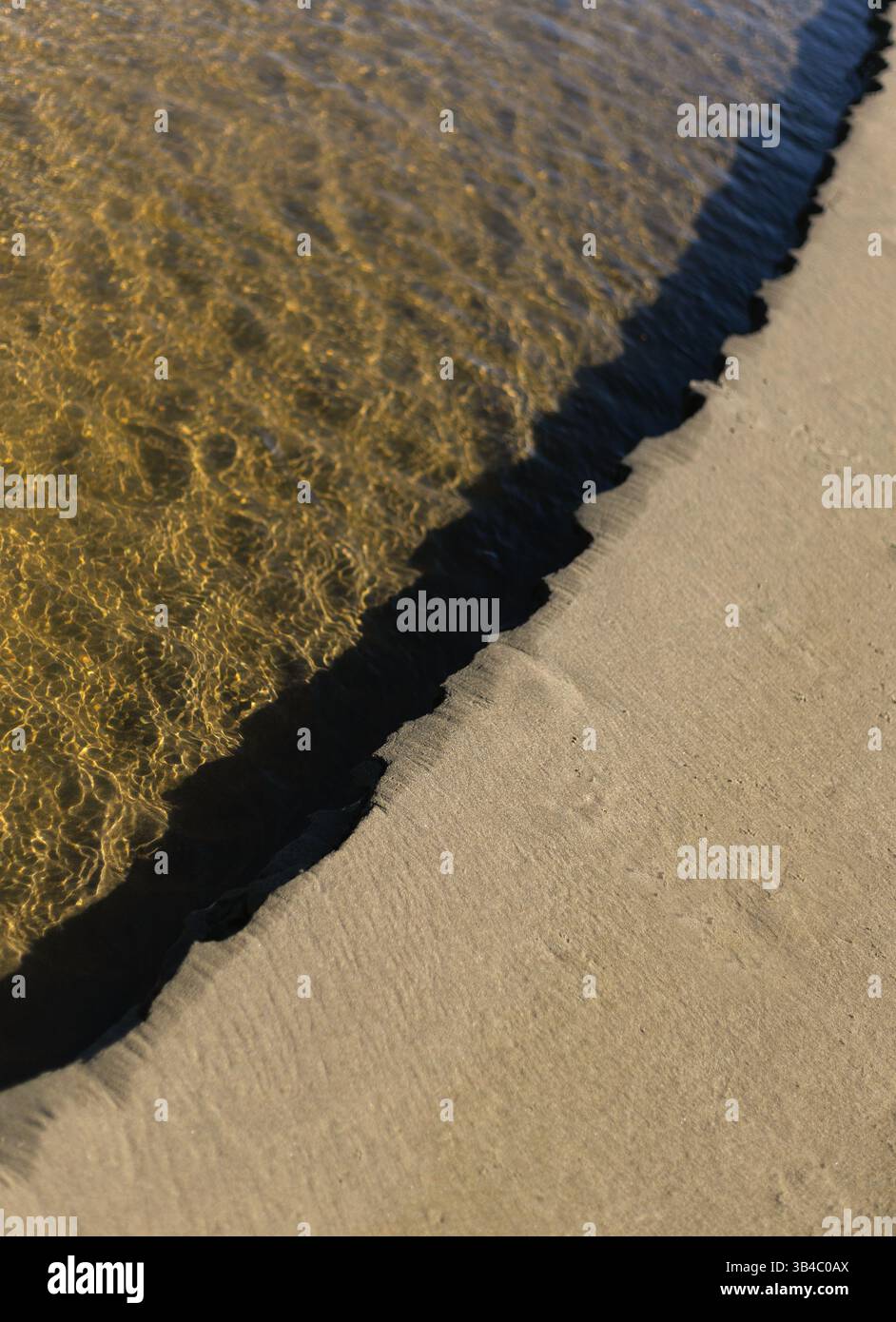 Sand ripples where it meets rippled water on a beach Stock Photo - Alamy