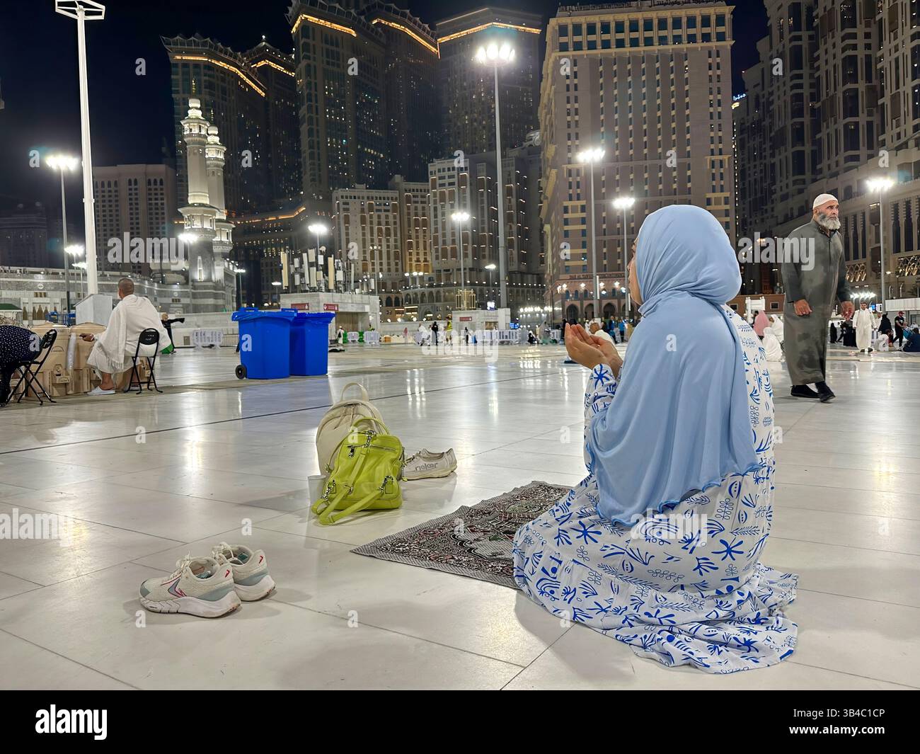 A girl in a hijab prays in the Al Haram mosque. Night prayer. Saudi ...