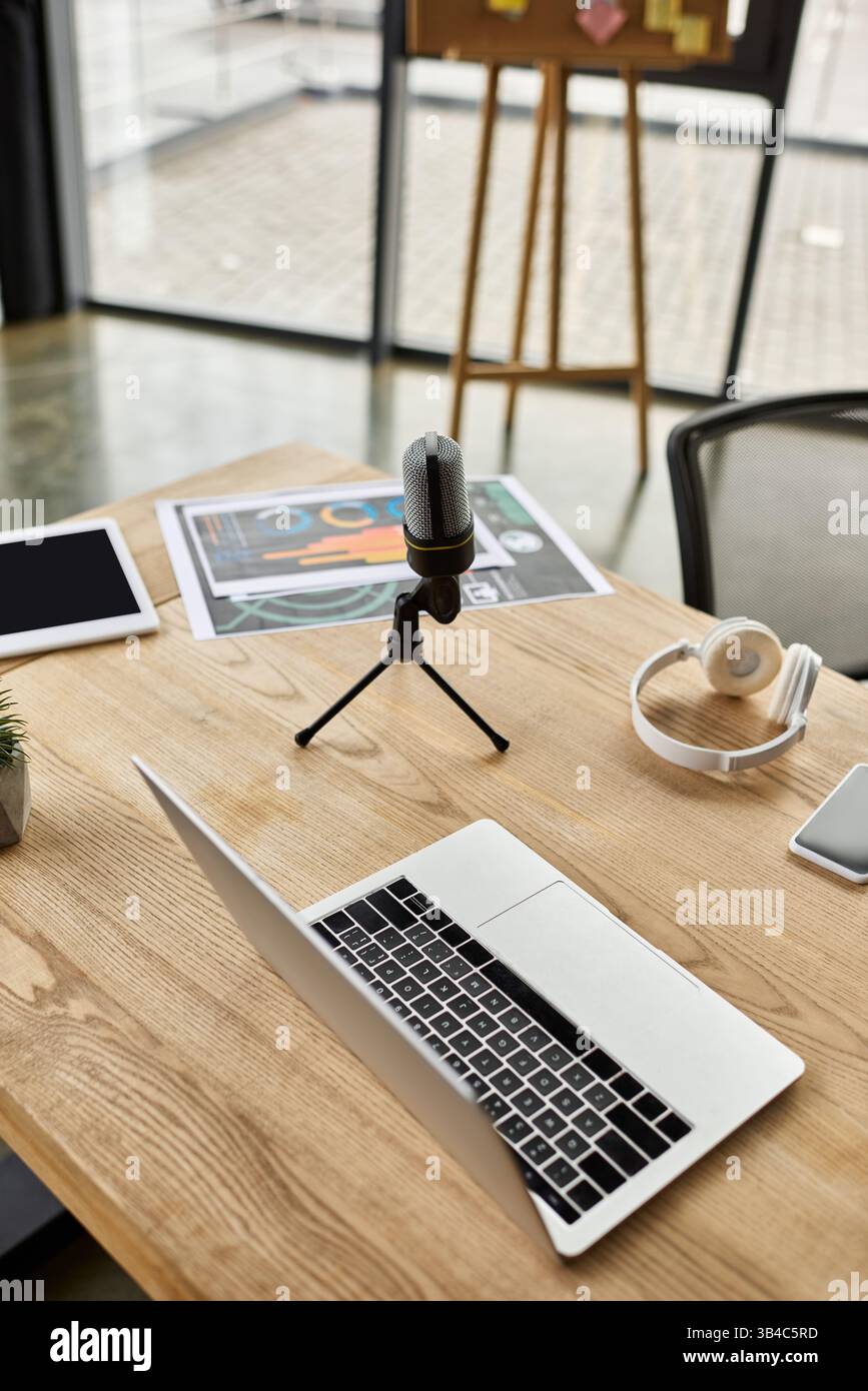 A modern office features a laptop, mic, headphones, and graphs to ...