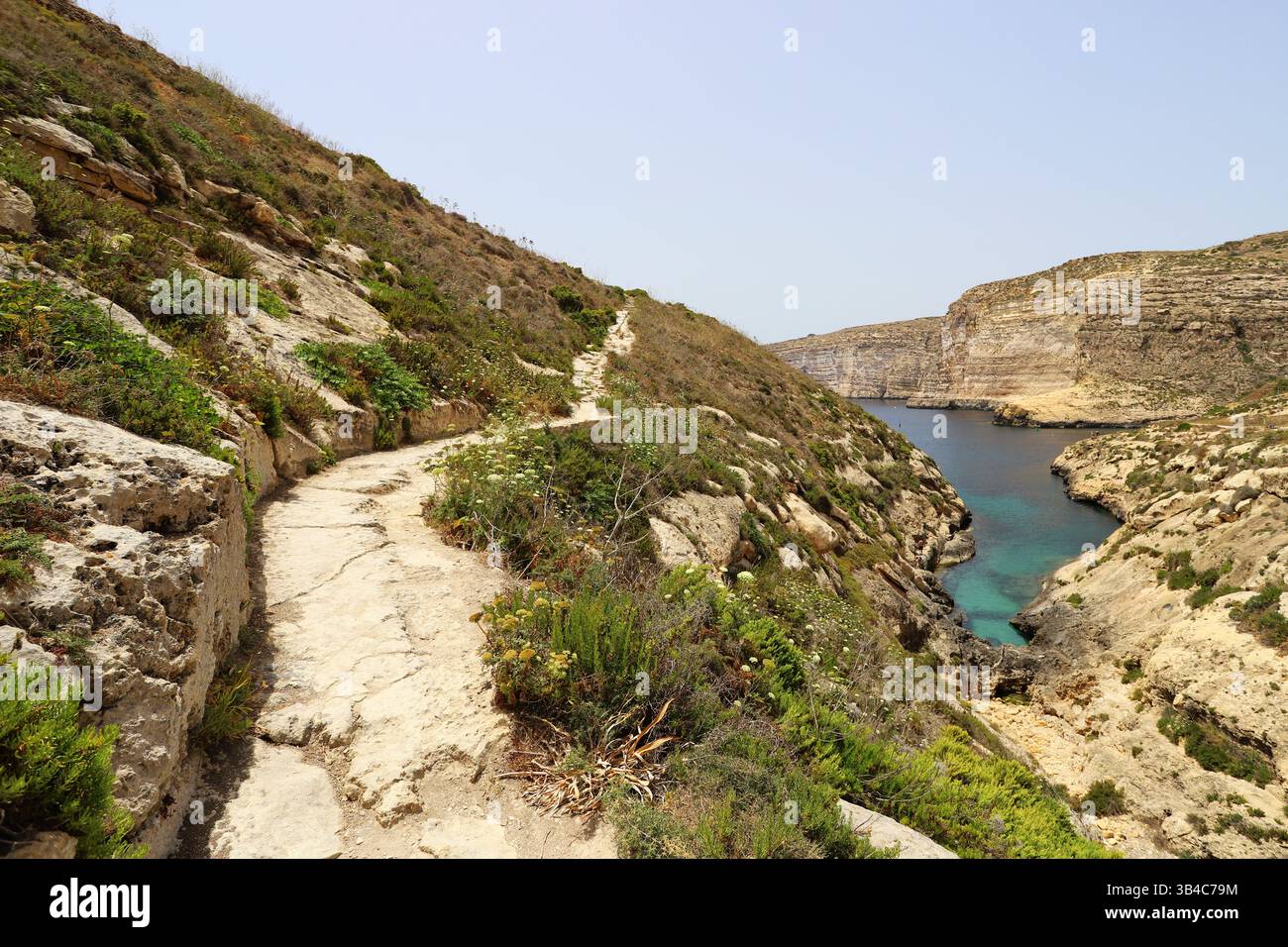 Rocky hiking trail along the cliffs near Wied il-Għasri, Gozo, Malta ...