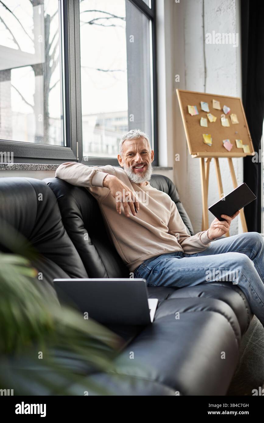 A cheerful man thrives in a stylish, well lit workplace filled with ...