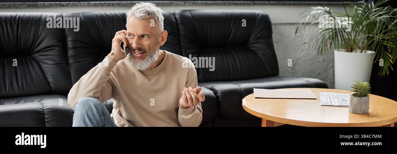 In a welcoming office, a man happily makes a phone call while seated ...