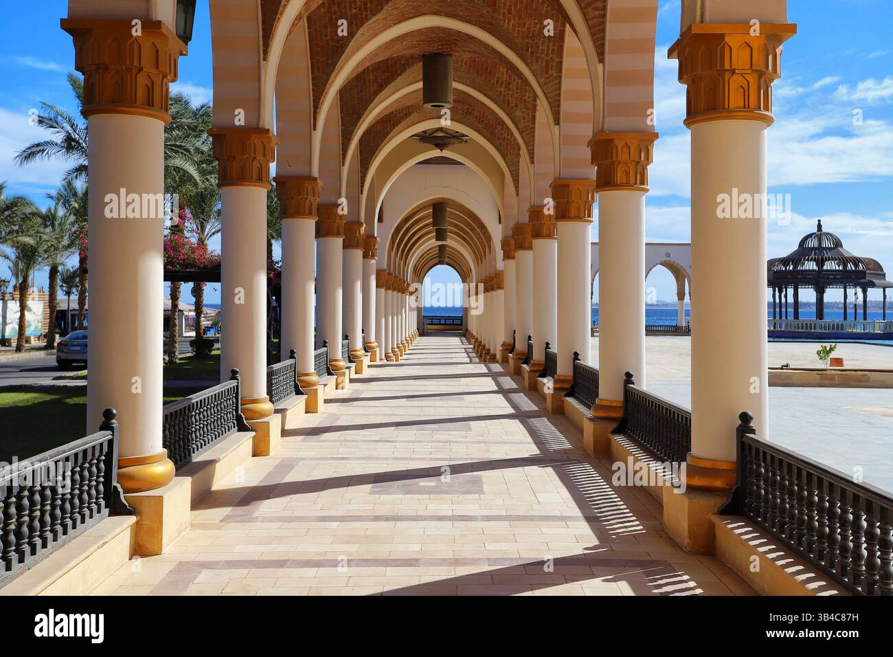 Ornamental corridor with Islamic-inspired arches and columns at a high ...