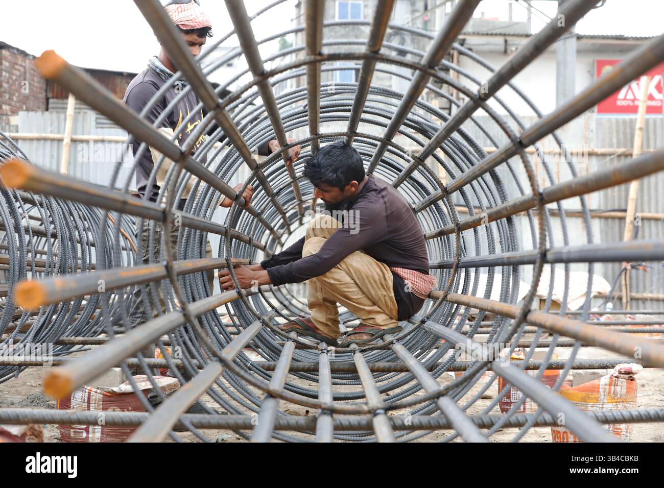 Dhaka, Bangladesh - April 30, 2025: Bangladeshi construction workers are working without any ...