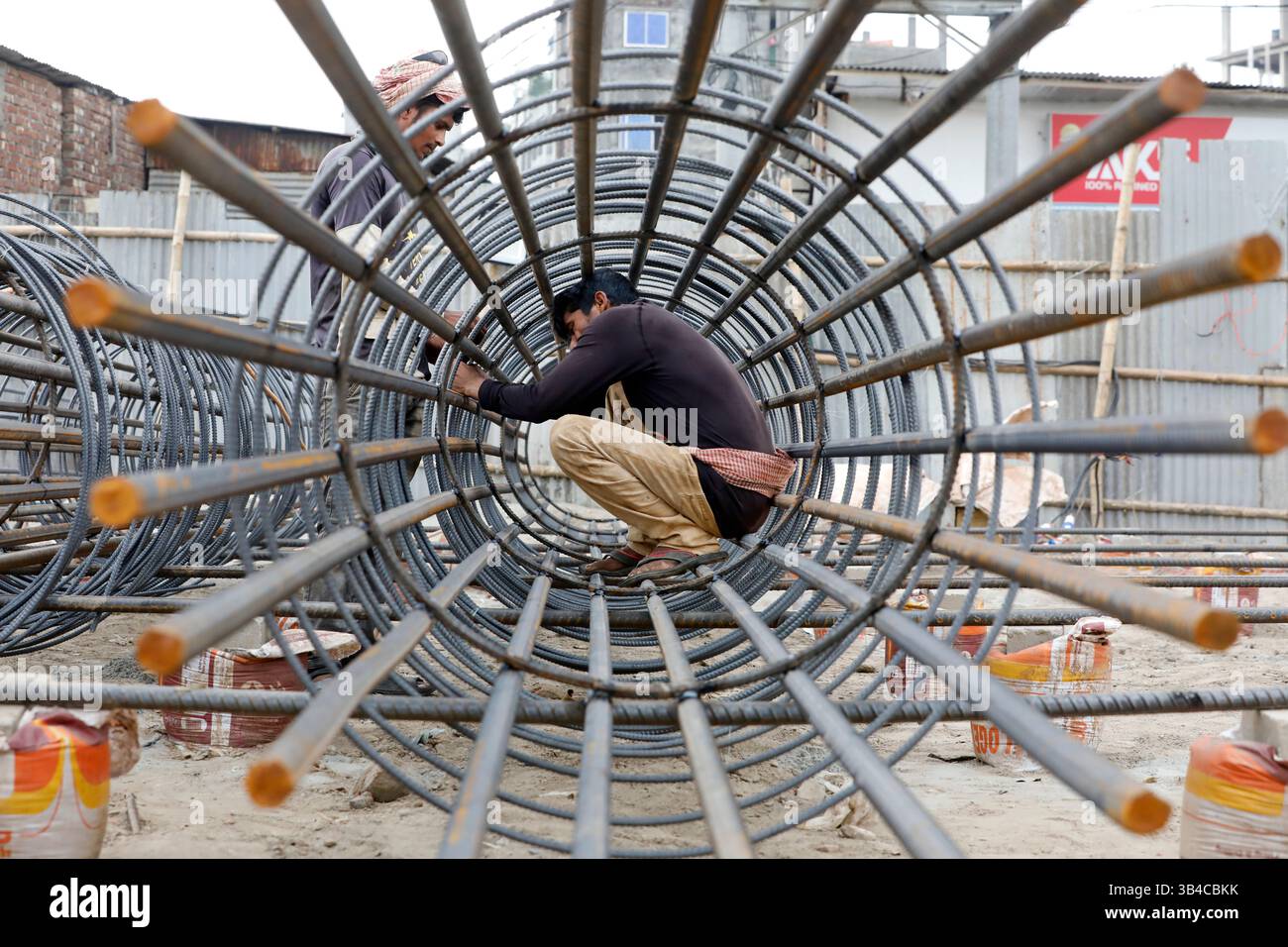 Dhaka, Bangladesh - April 30, 2025: Bangladeshi construction workers are working without any ...