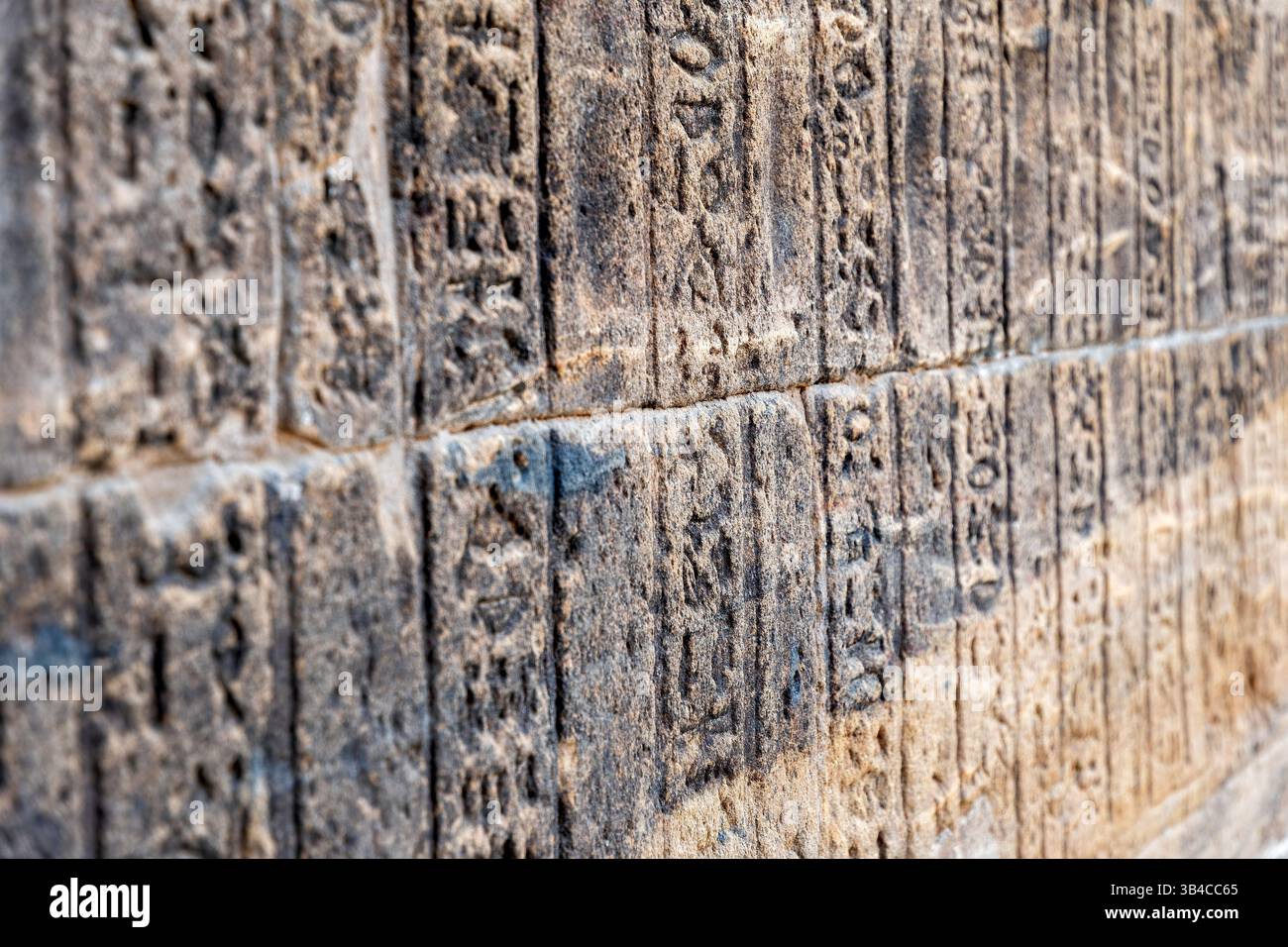 Close-up shot of weathered stone blocks covered in ancient Egyptian ...