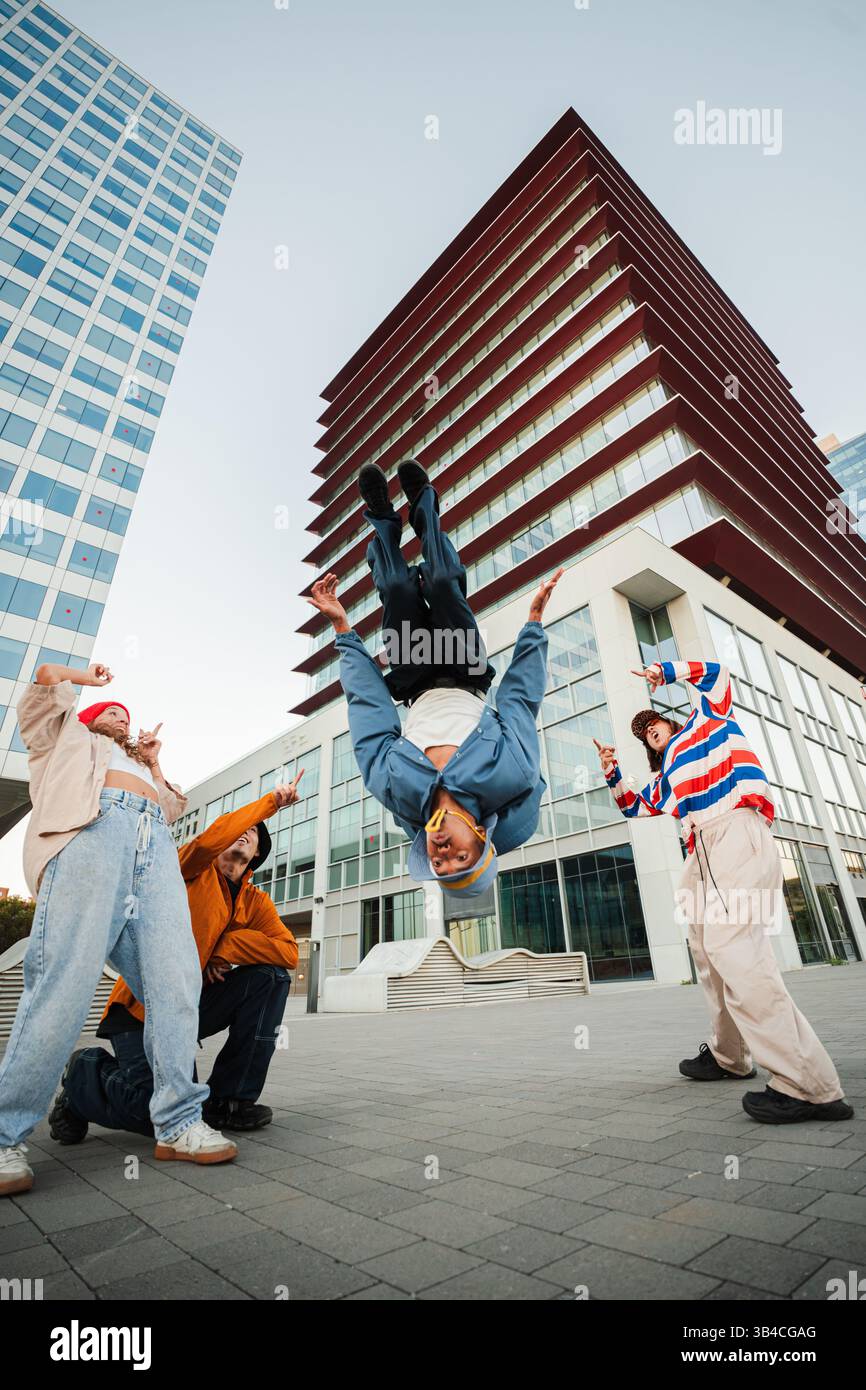 Lively group of friends showcasing impressive acrobatic flip and ...