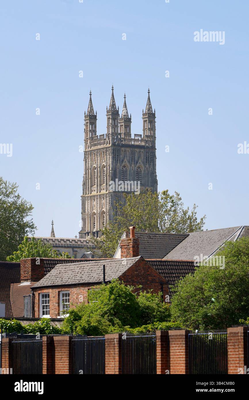 The tower of Gloucester Cathedral, seen over the roofs of homes in ...