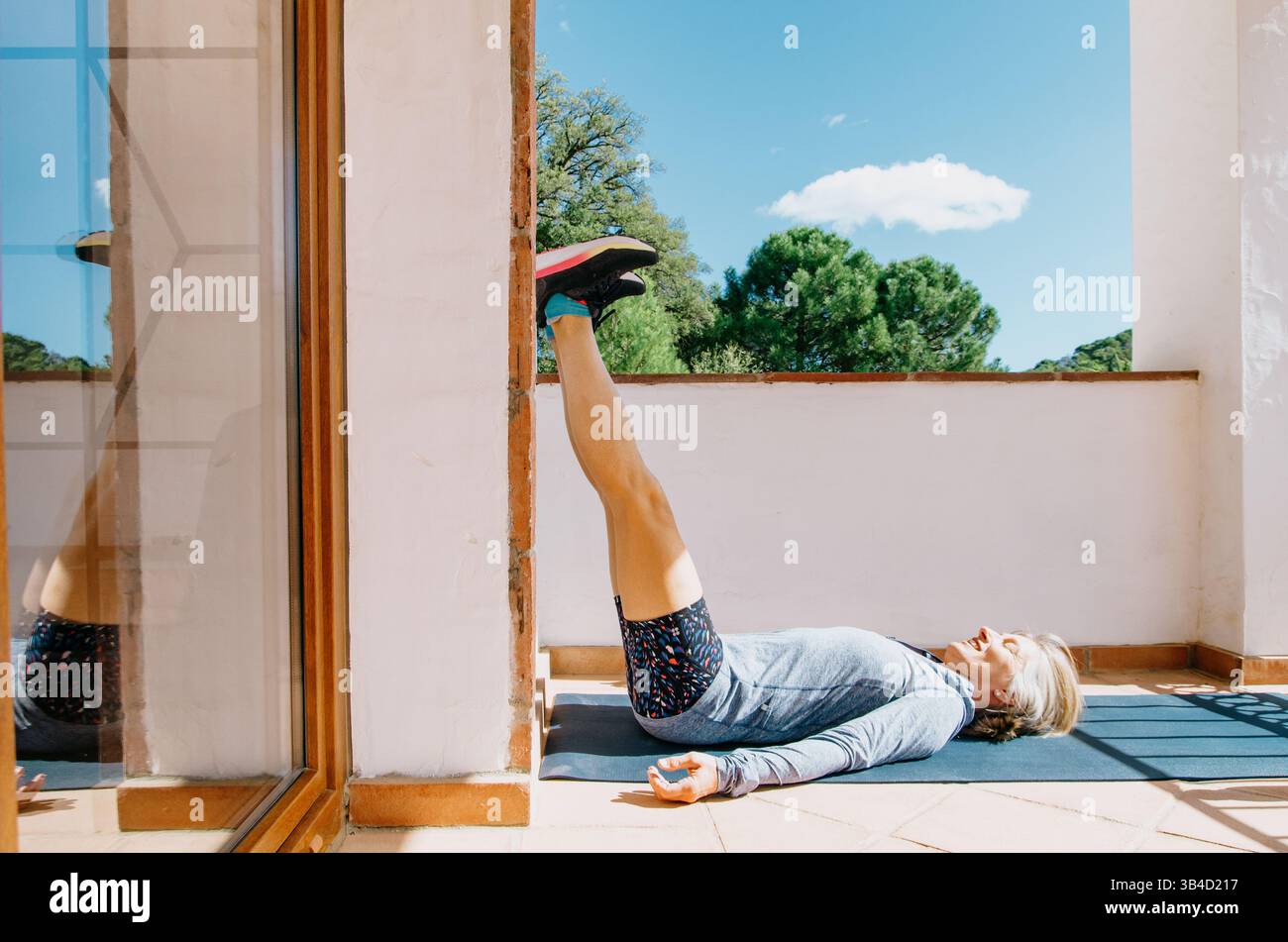 Restorative yoga for runners: woman doing legs up the wall pose on ...