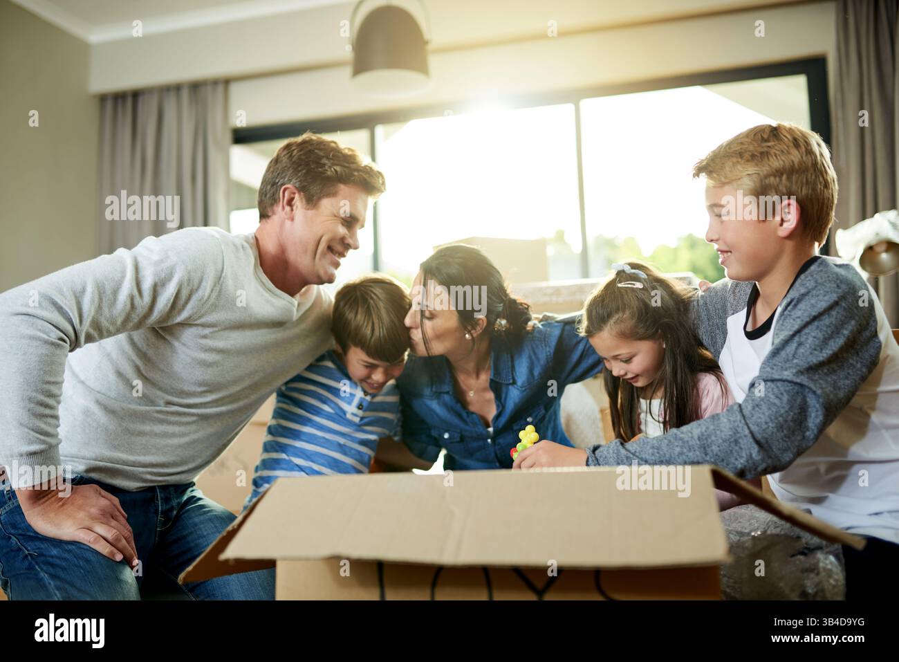 Bonding, boxes and family packing in new home with sorting items for ...